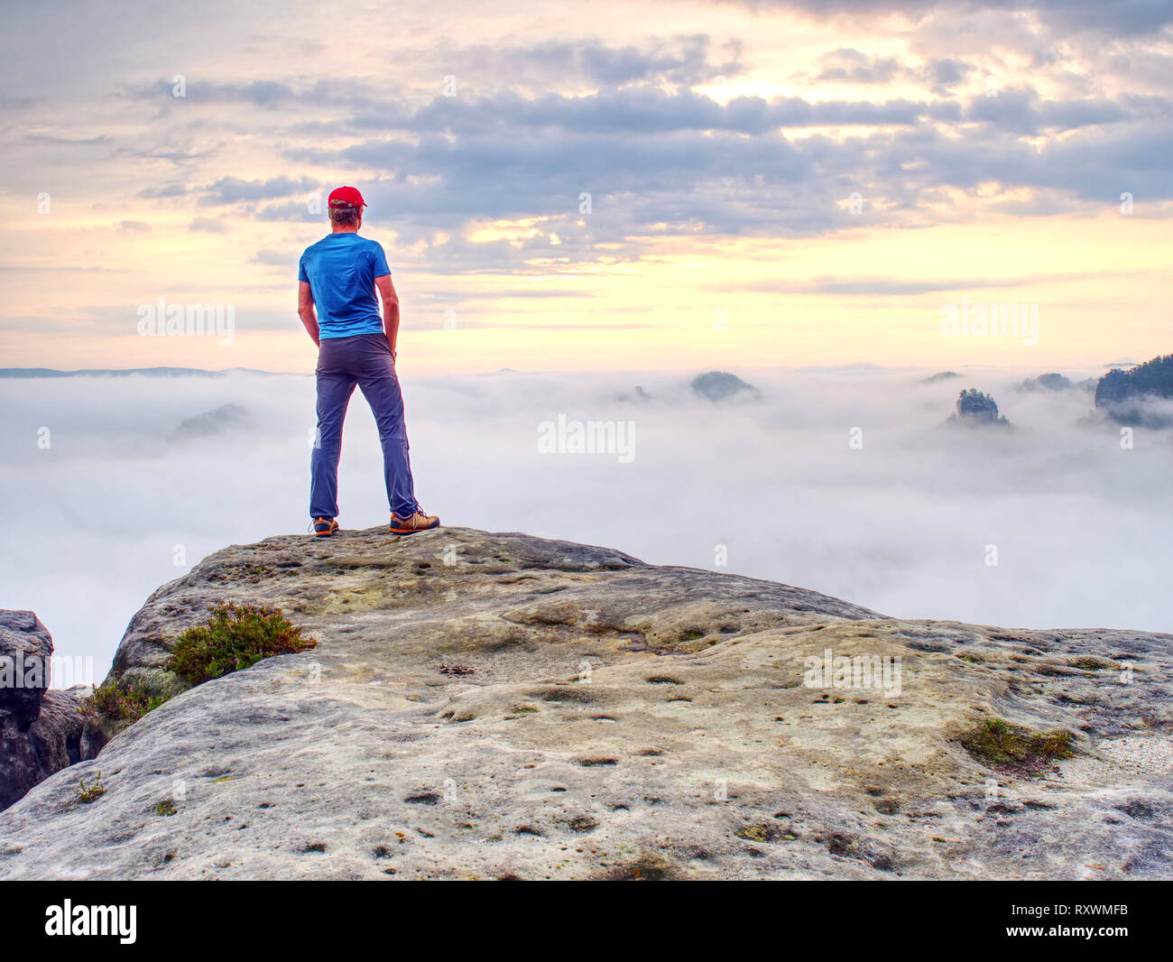 Tall guy with hands in pocket in blue shirt standing and watch the ...
