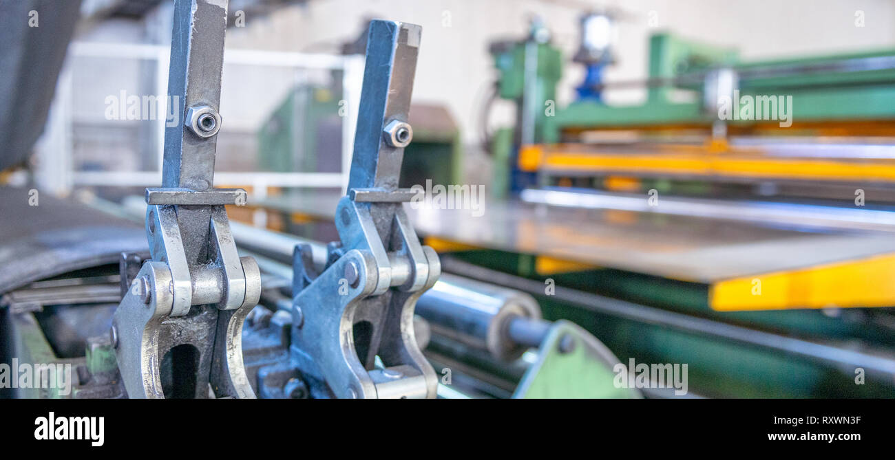Levers for metal coils cutter machine, industrial plant Stock Photo - Alamy