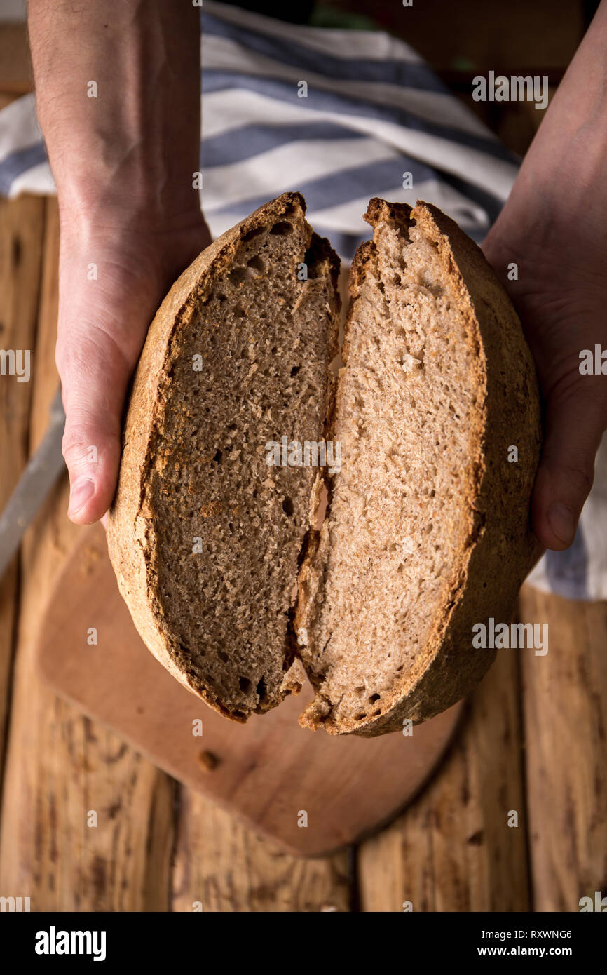 Bread is broken into two parts Stock Photo - Alamy