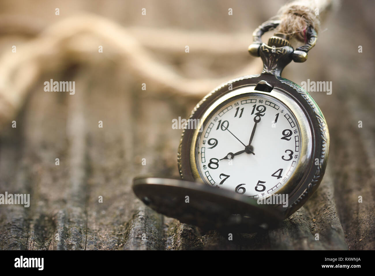 Ancient Clock Time 8.00 am Placed on old wooden in the morning sunshine ...