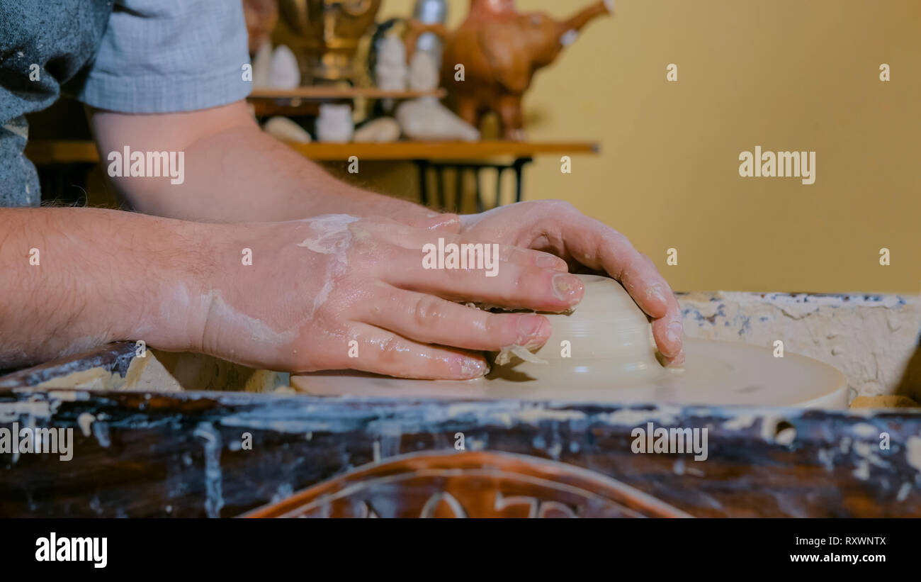 Professional potter shaping mug in pottery workshop Stock Photo - Alamy