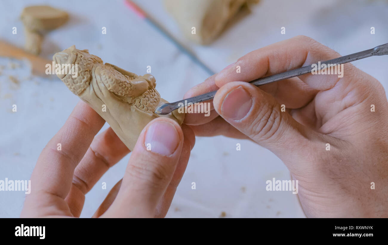Potter making clay figure for board game Stock Photo - Alamy