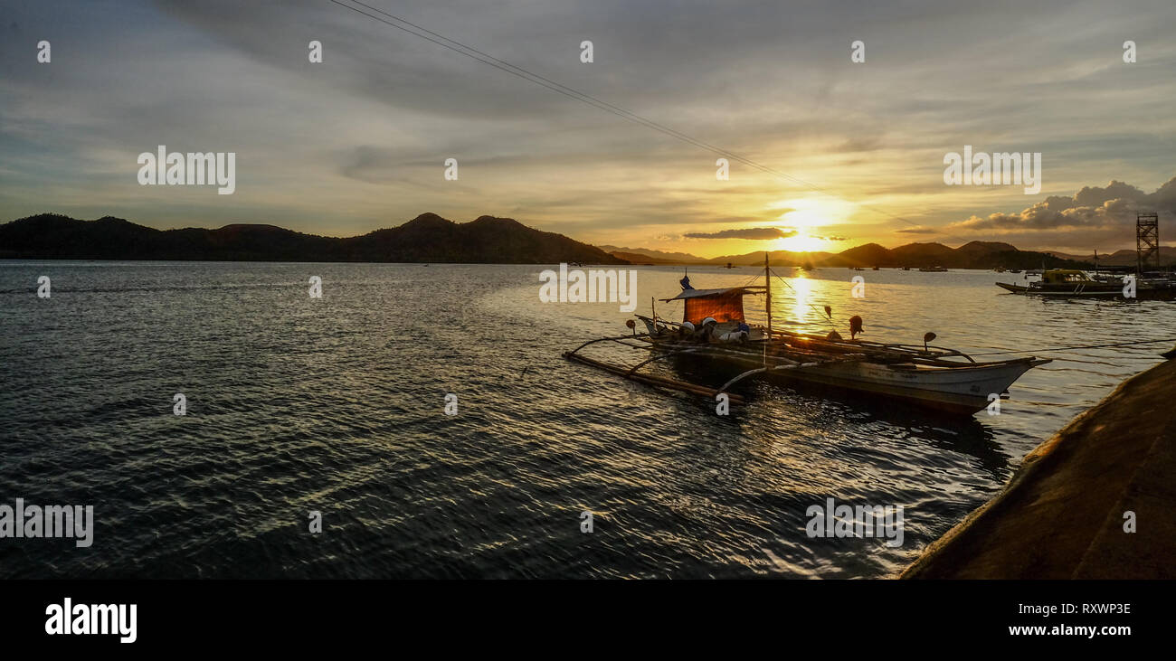 Orange sunset landscape of Coron Main Pier, Palawan Island, Philippines ...