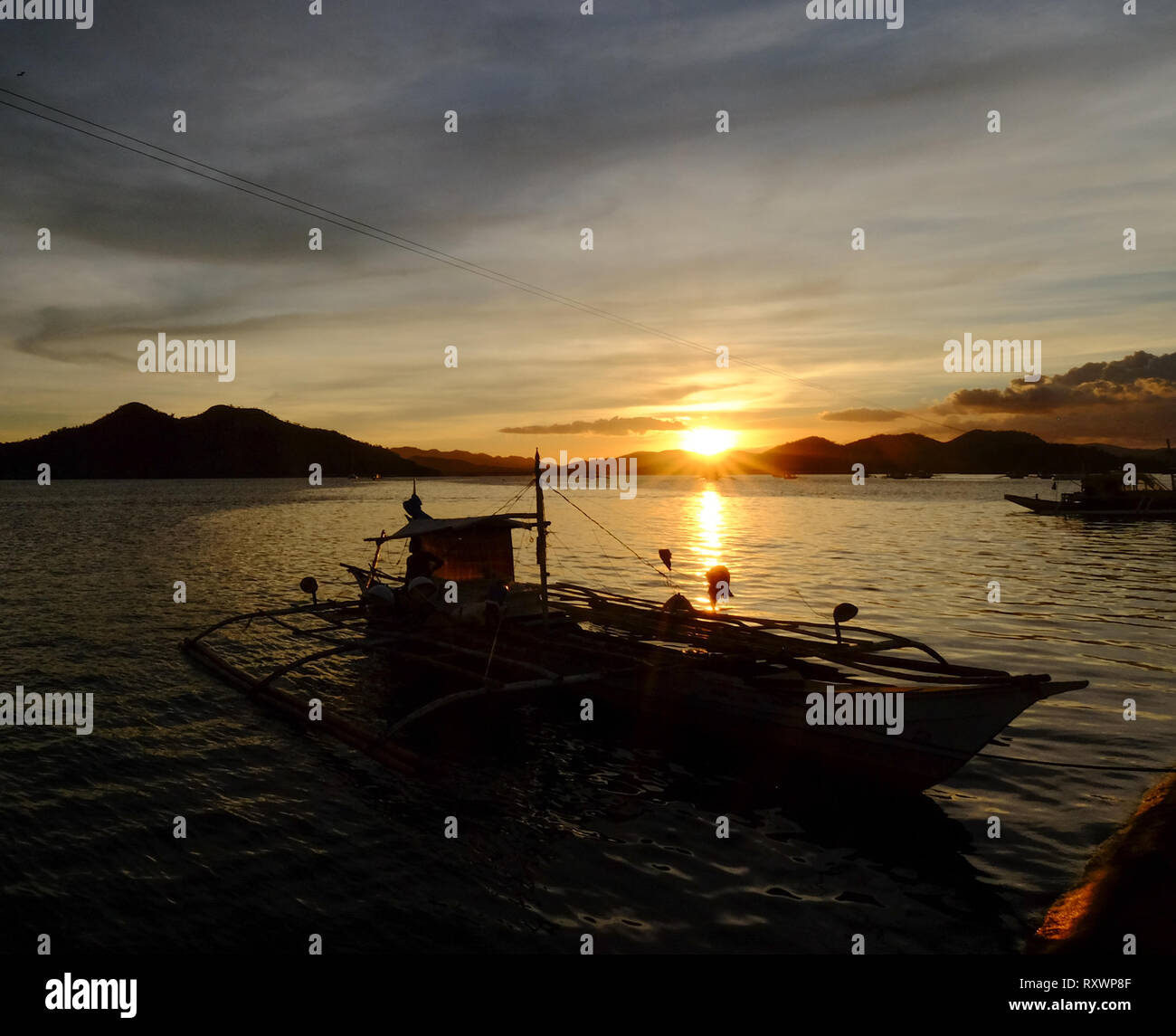 Orange sunset landscape of Coron Main Pier, Palawan Island, Philippines ...