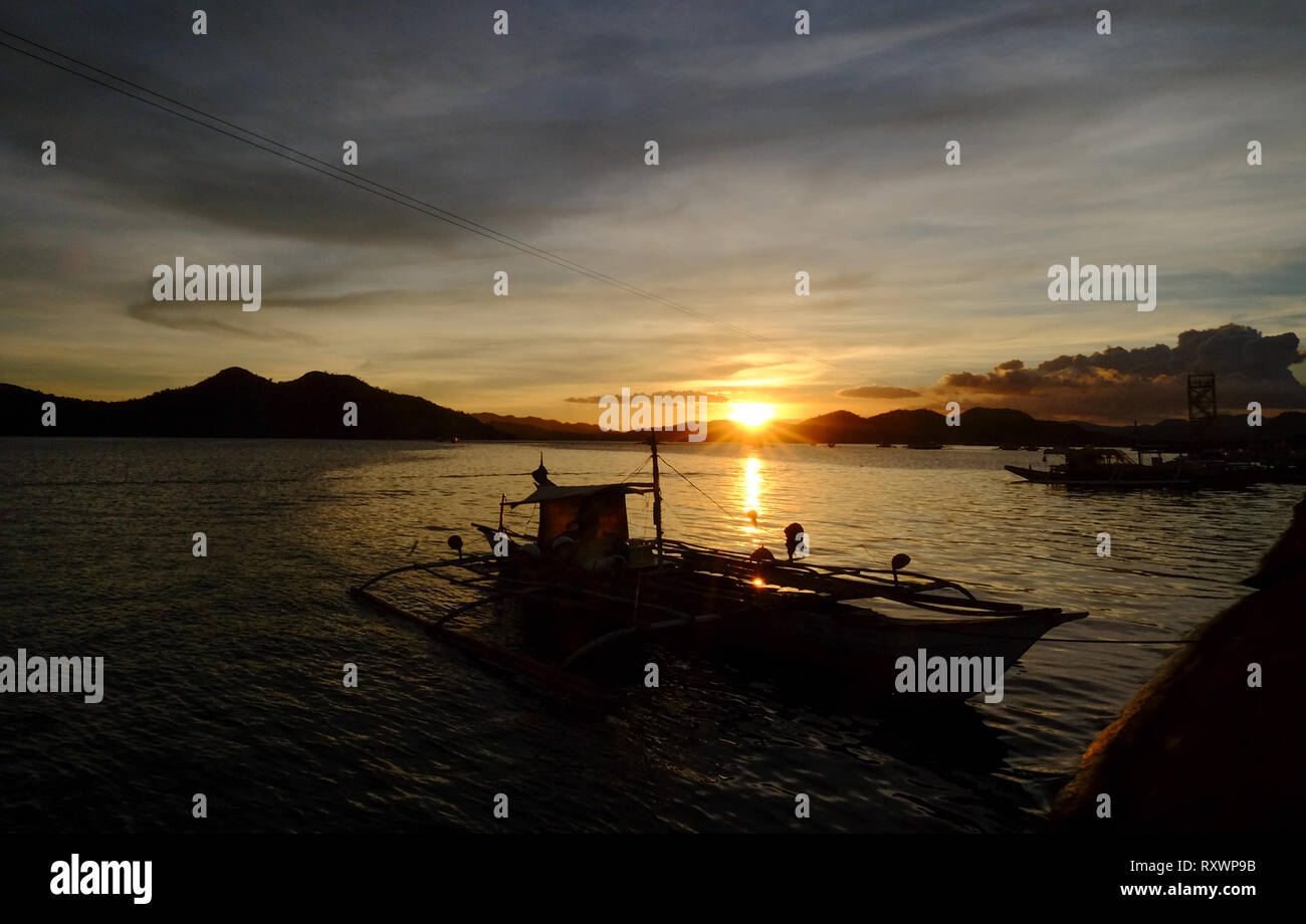 Orange sunset landscape of Coron Main Pier, Palawan Island, Philippines ...