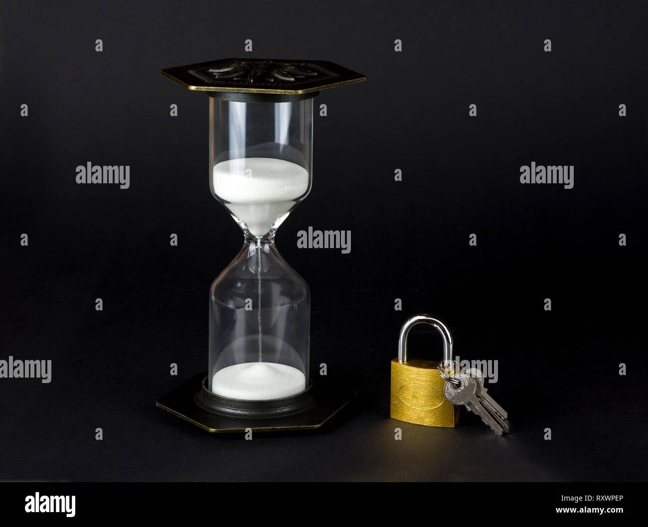 Hourglass with the lock. Stop the time concept Stock Photo - Alamy
