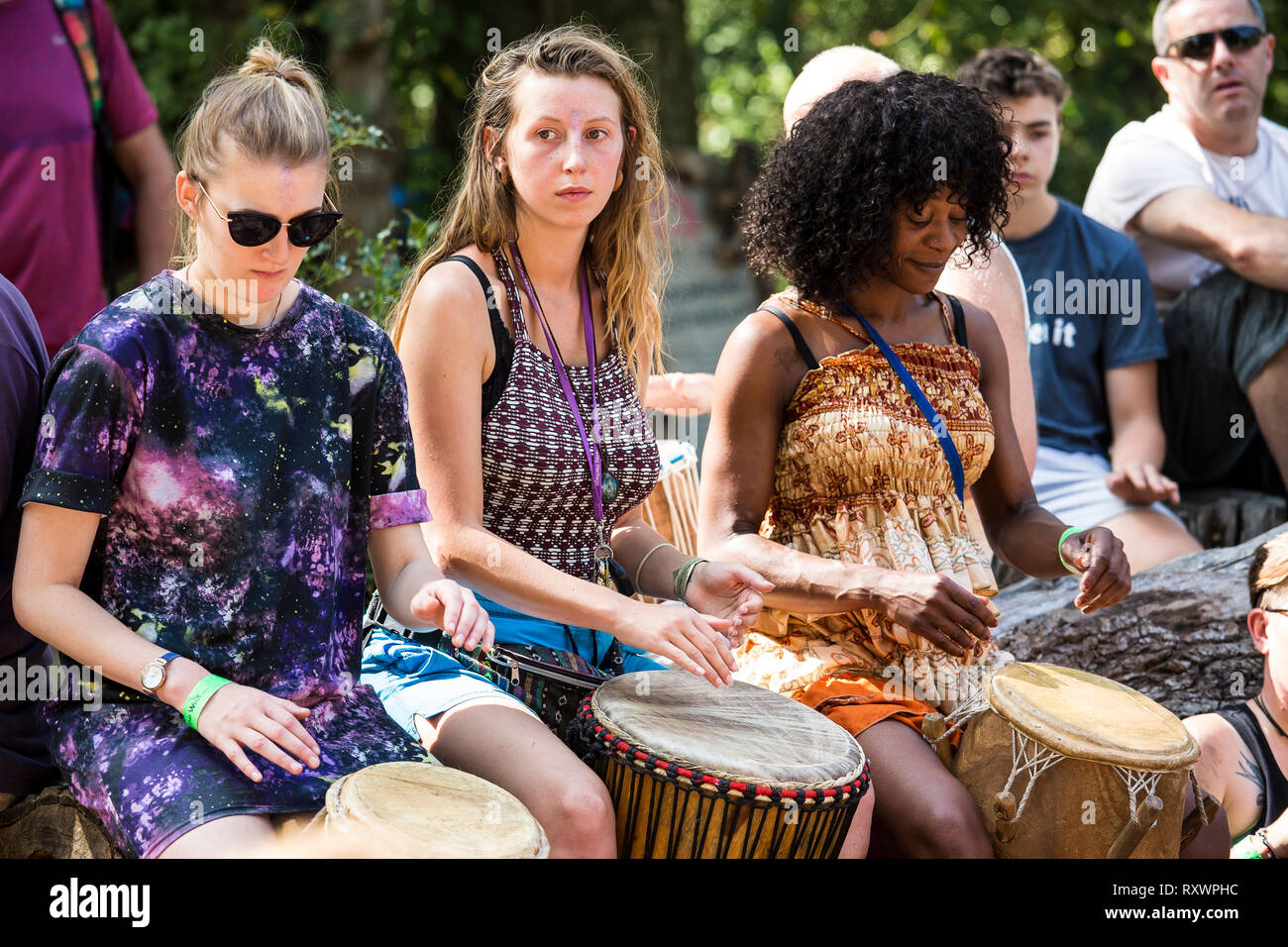 Festival goers attend an outdoor drumming workshop in the woods at Into ...
