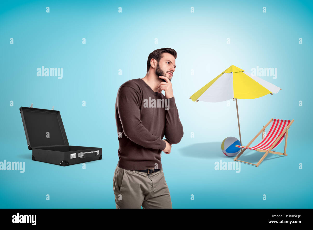 Thinking man with open suitcase, beach chair, ball and umbrella on blue ...