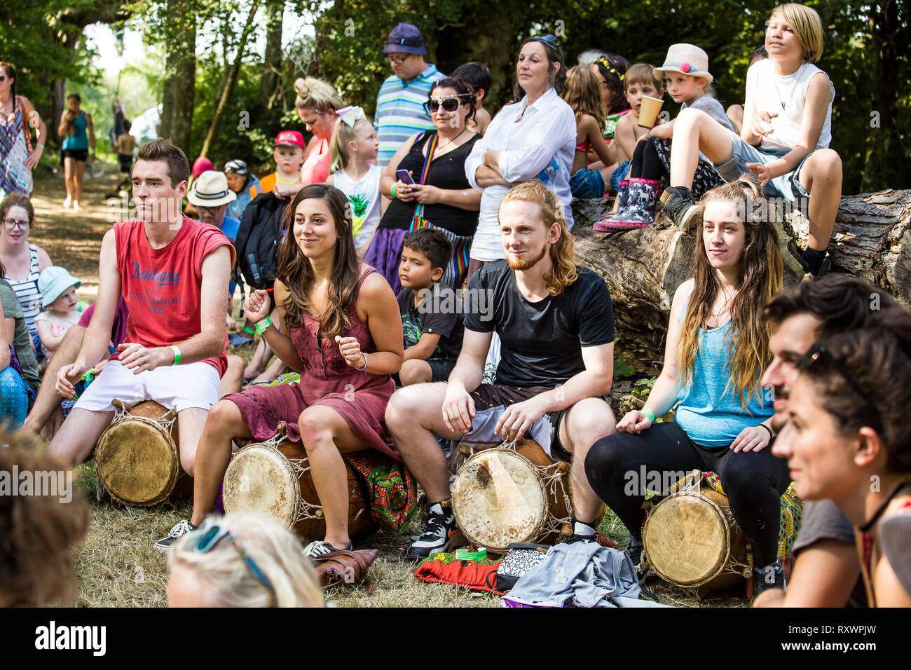Festival goers attend an outdoor drumming workshop in the woods at Into ...