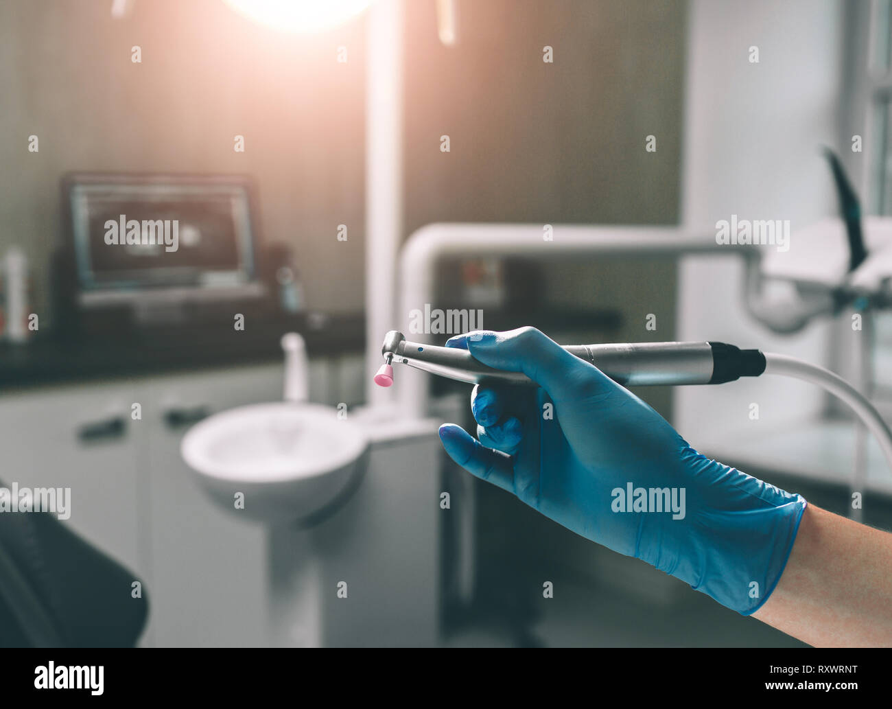 Detail of hand holding dental tools in dental clinic. Dentist Concept ...
