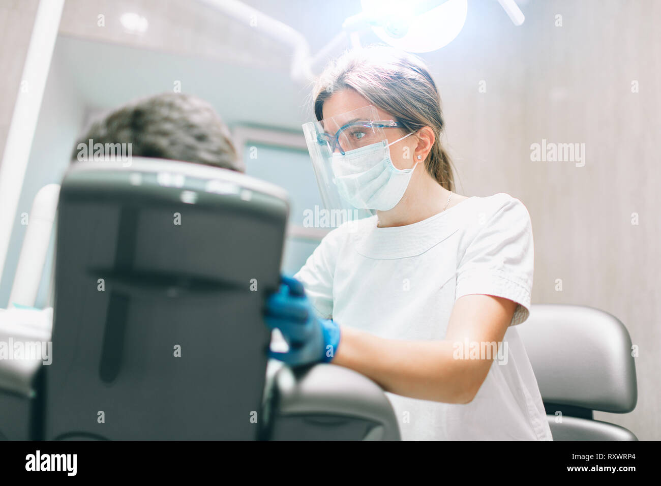 Portrait of female dentist . She examining a patient's teeth Stock ...
