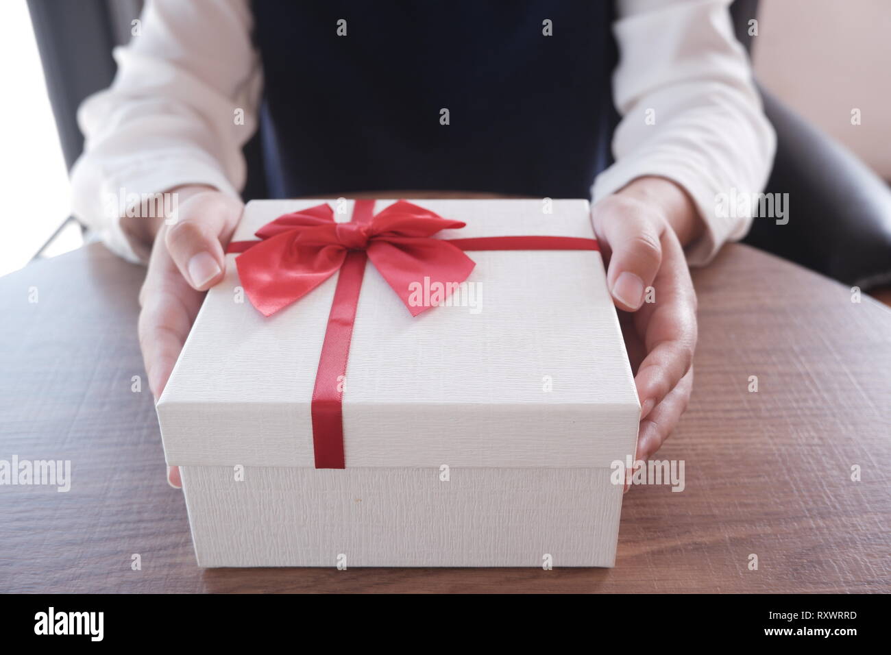 Hands giving or receiving a present Stock Photo - Alamy