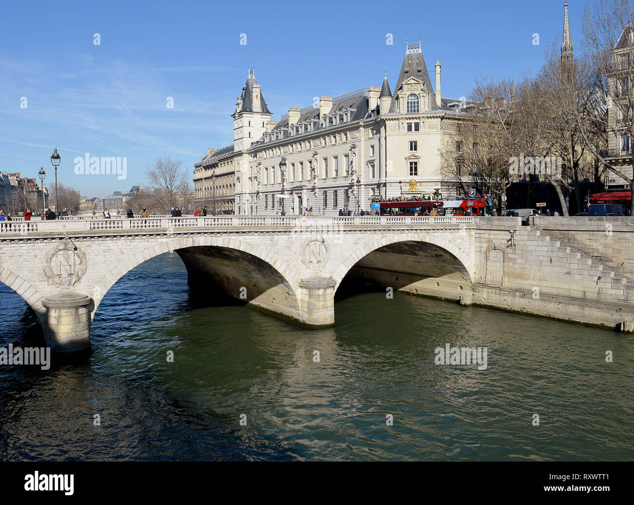 Sunday walkers and tourists mill around the bridge, Pont Saint-Michel ...