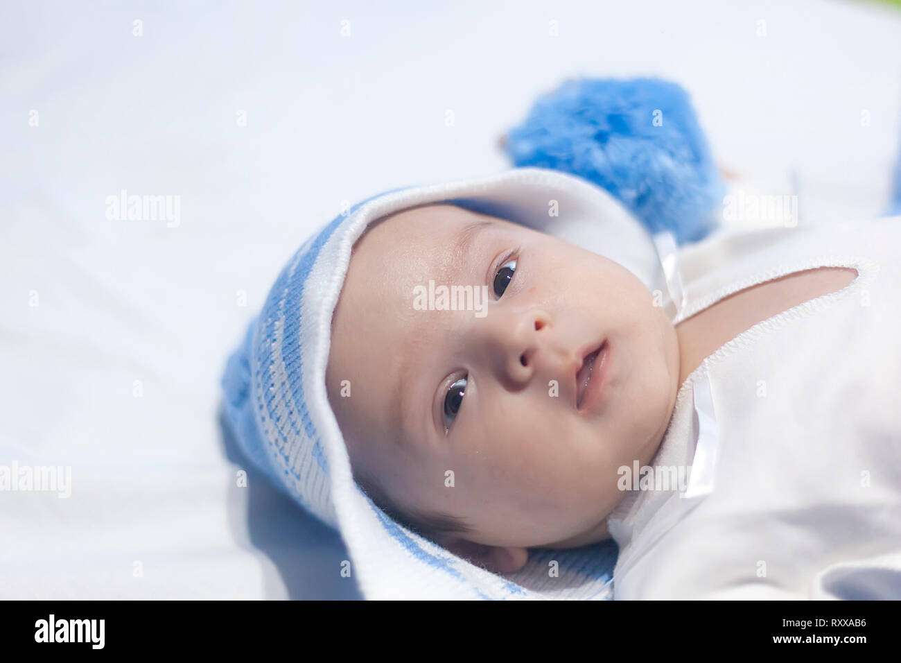 Beautiful newborn baby boy lying on white background. Copy space Stock Photo - Alamy