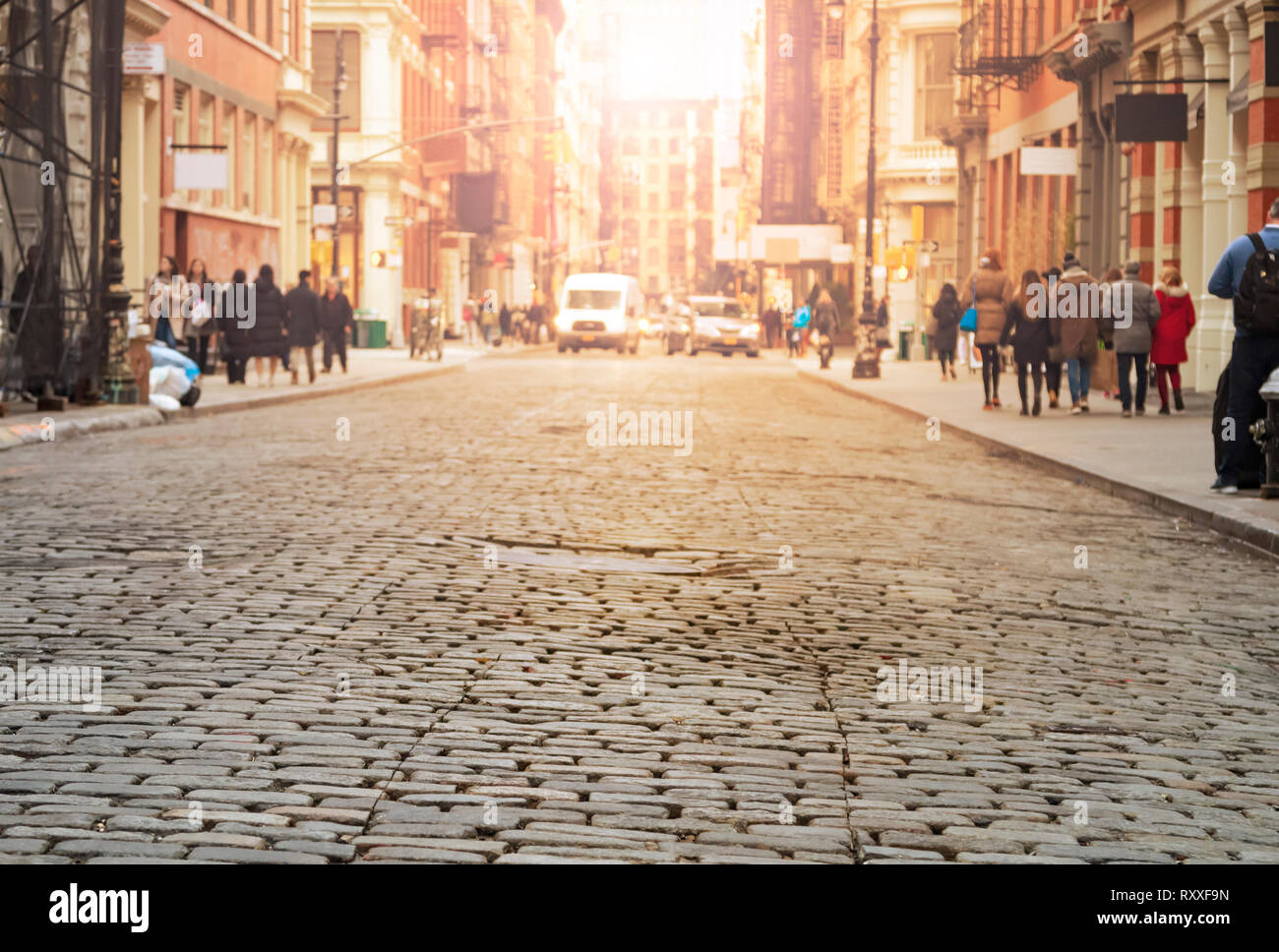 View of cobblestone covered Greene Street with bright sunlight ...