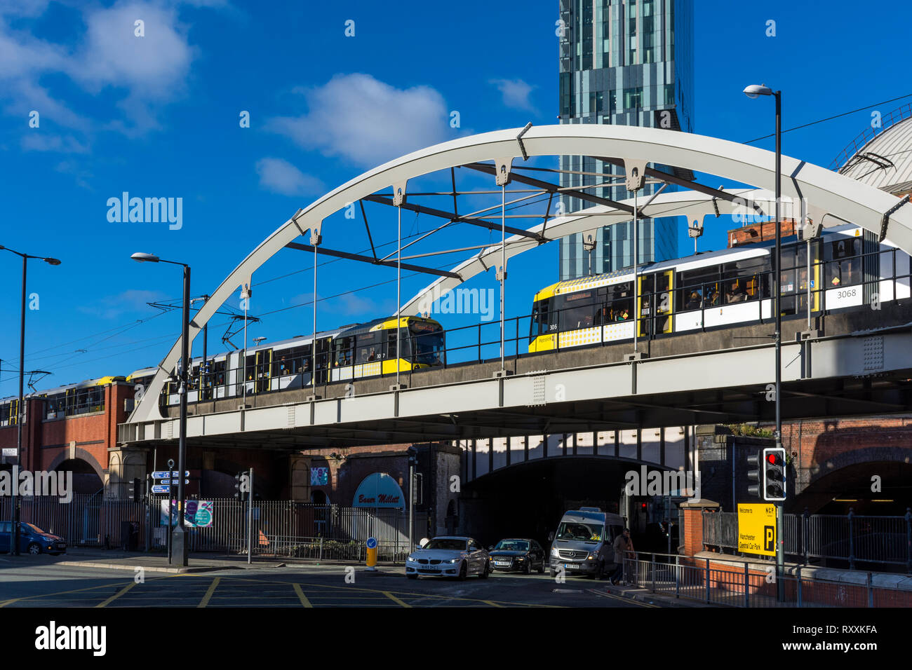 Two Metrolink trams crossing the Great Bridgewater Street bridge, with ...