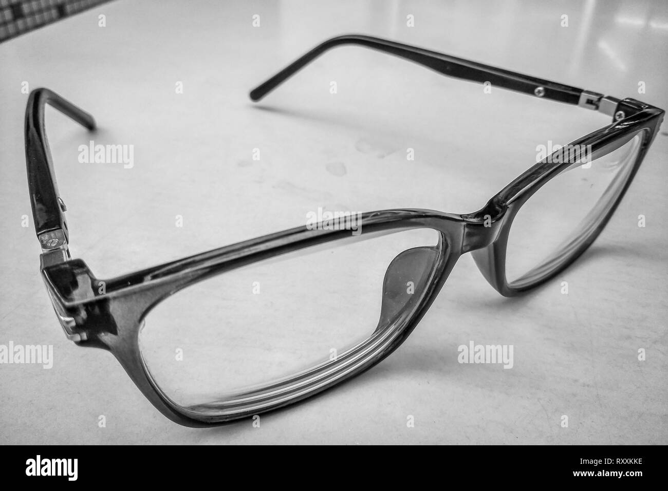 Black and white photo of spectacles kept on a white table Stock Photo ...