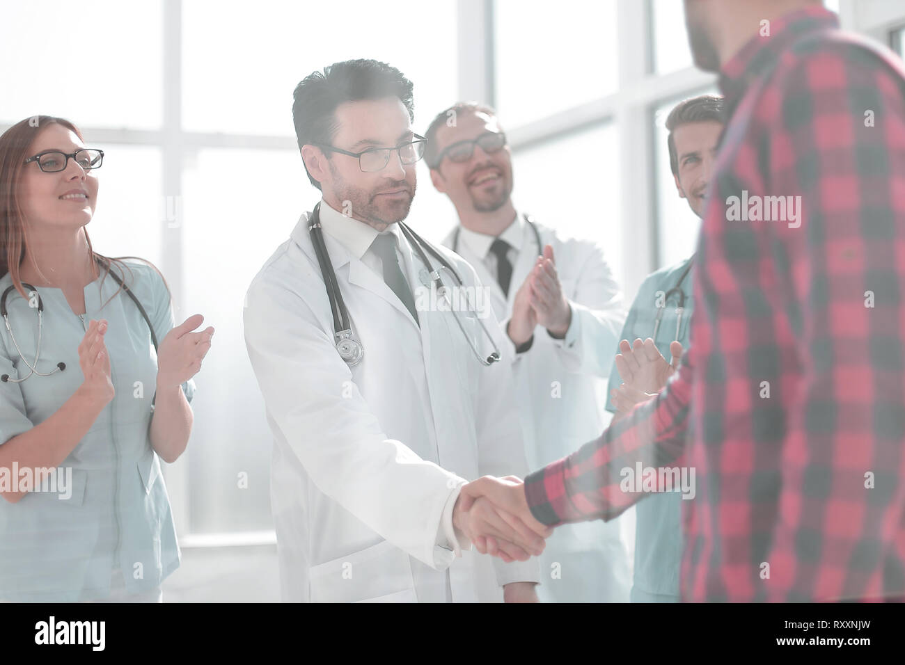Thankful patient shaking doctors hand Stock Photo - Alamy