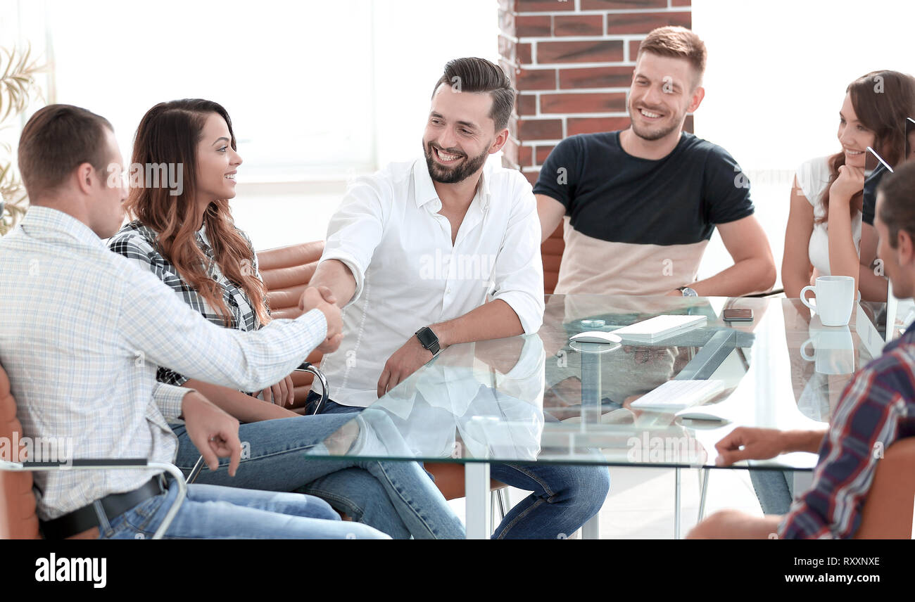 handshake of business partners sitting at the table Stock Photo - Alamy