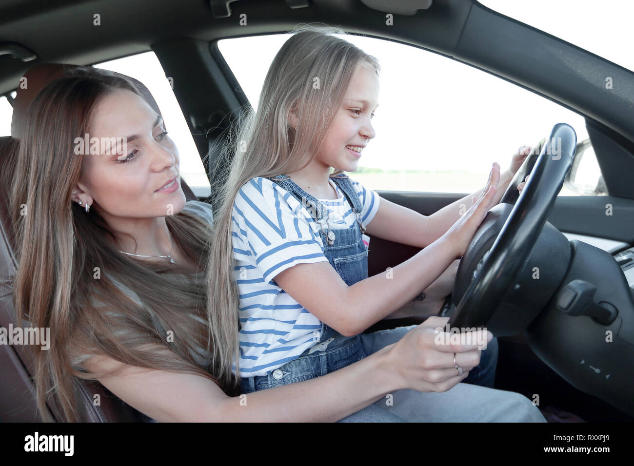 mom teaches her little daughter to drive Stock Photo - Alamy