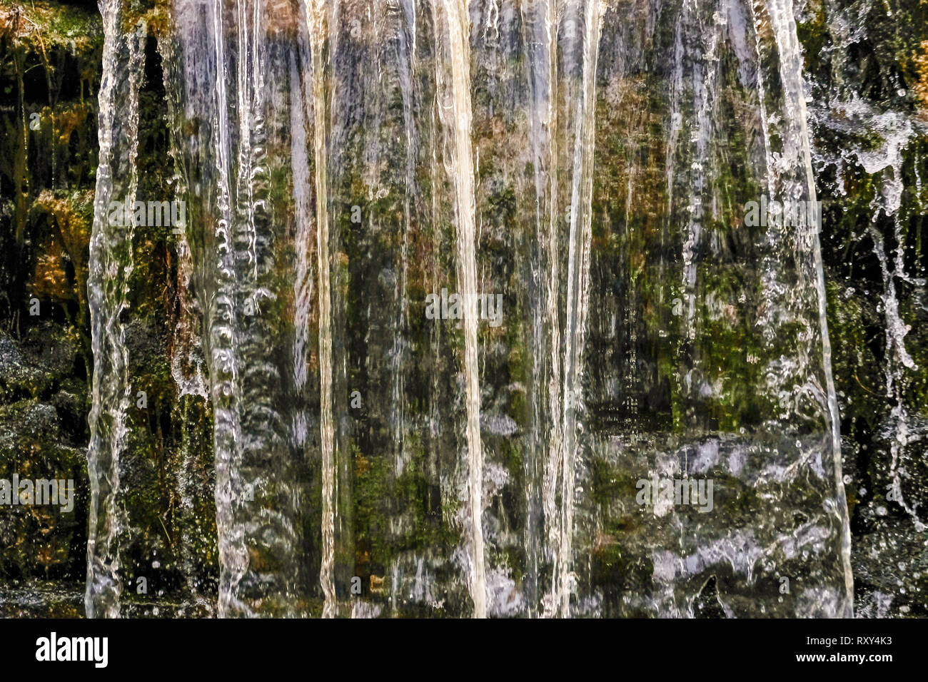 Closeup of a section of the waterfall flowing over the dam with algae ...