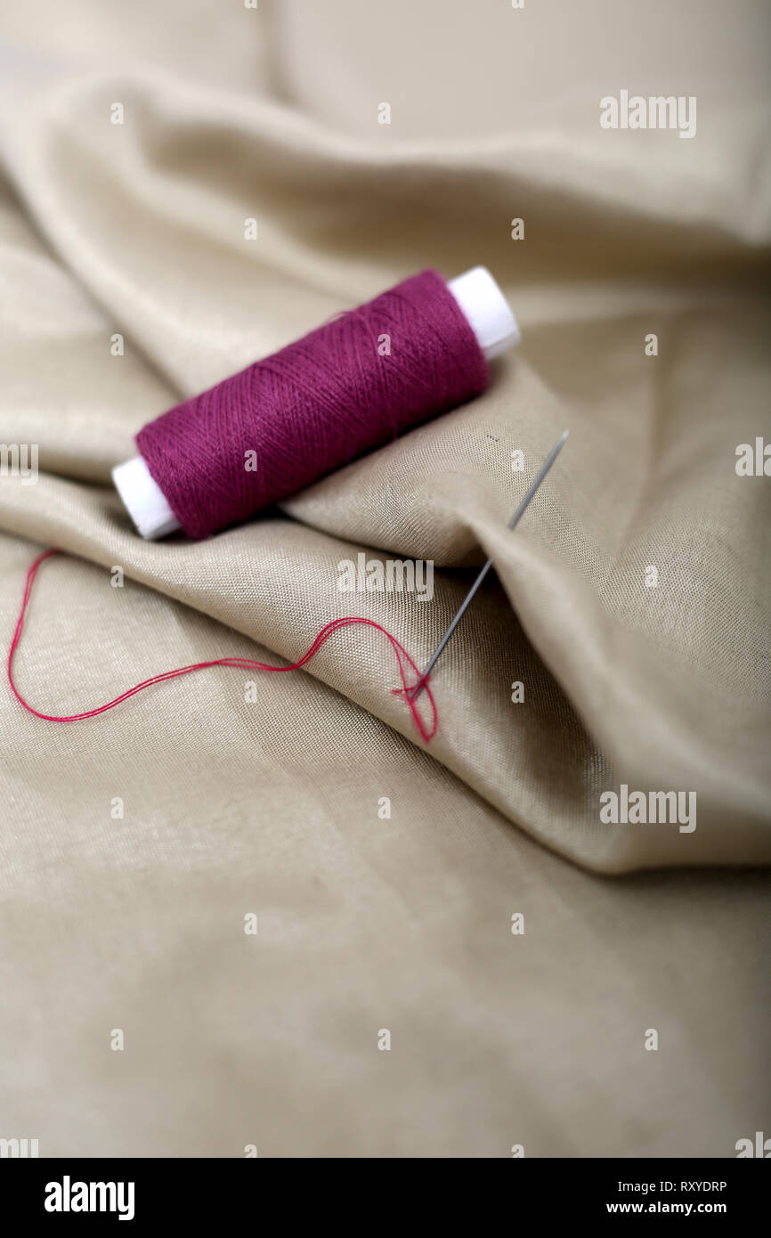 Photo of thread and needle attached in cloth with Sewing thread Stock ...