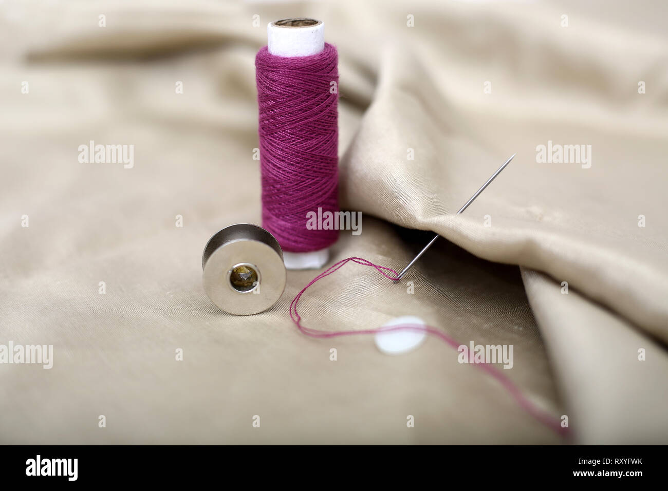 Photo of thread and needle attached in cloth with Sewing thread and ...