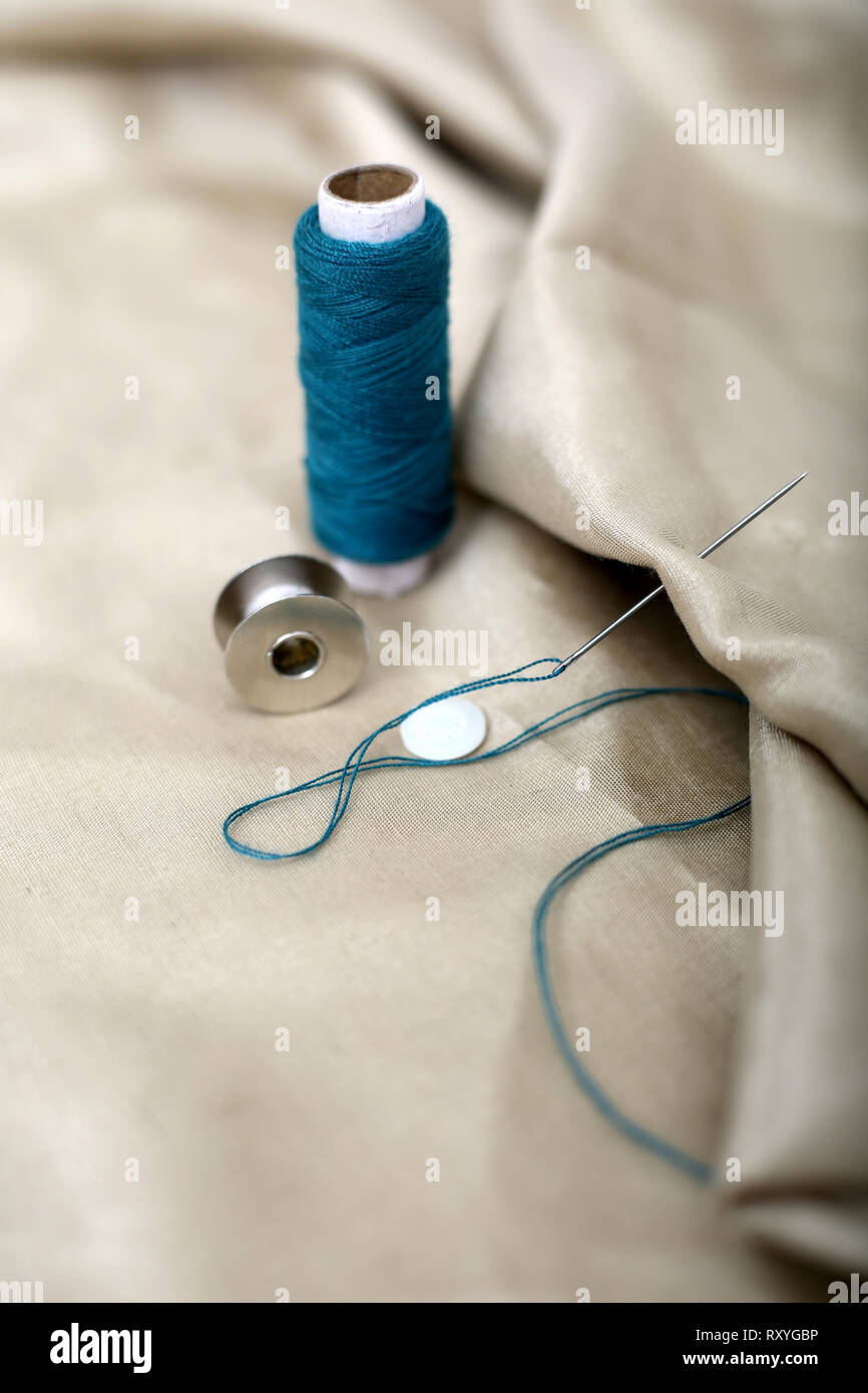 Picture of needle attached in cloth with Sewing thread and bobbin Stock ...