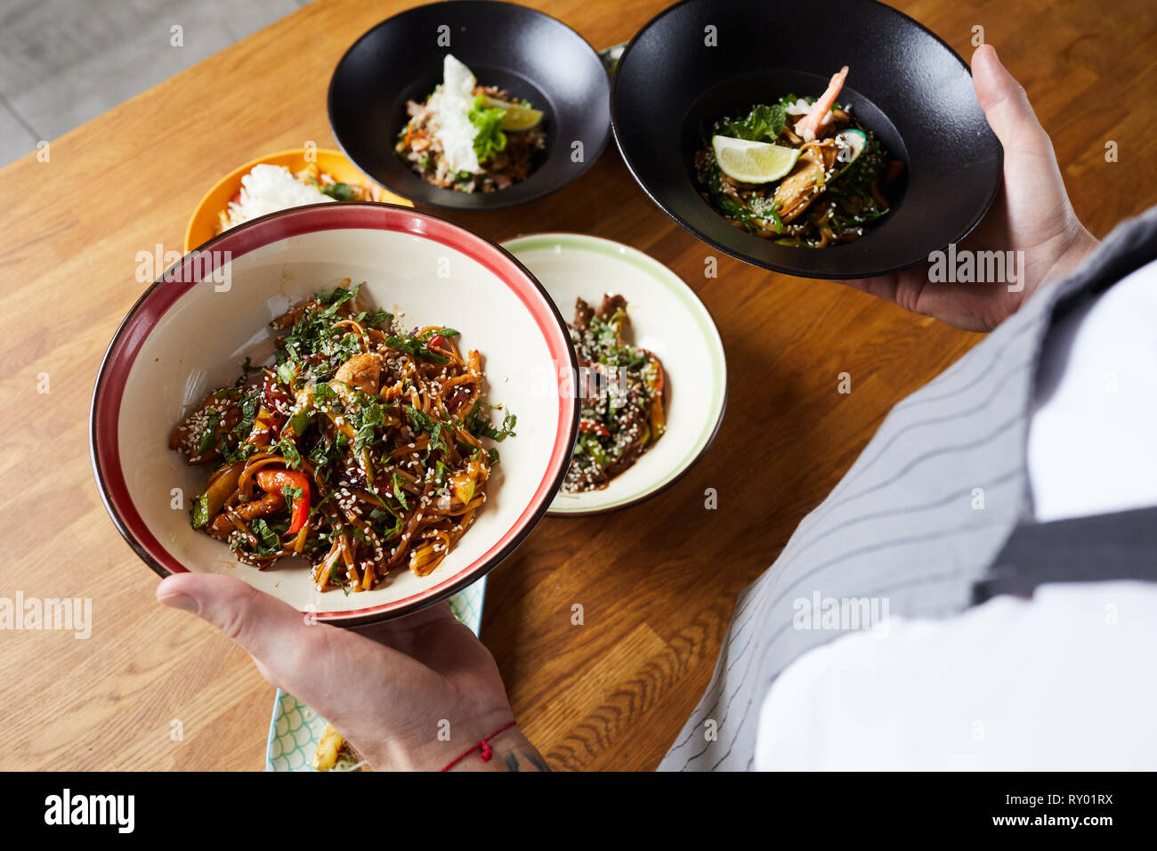 Waiter Serving Asian Food Stock Photo - Alamy