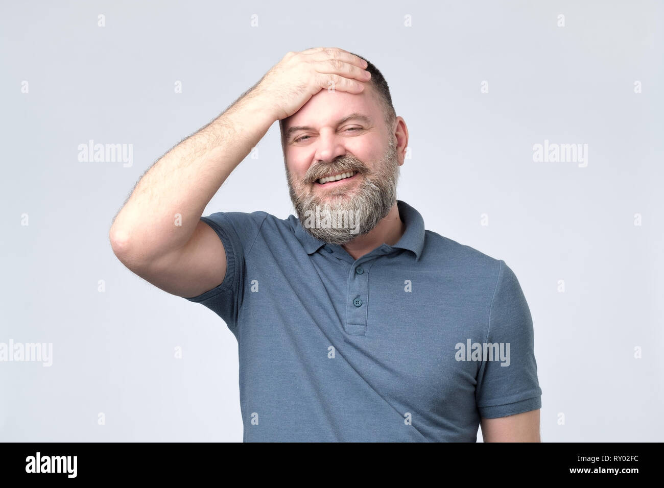 handsome mature man hold his head in hand forgotten something Stock Photo - Alamy