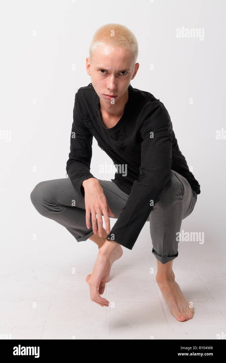 Slim man 20s crouching hi-res stock photography and images - Alamy