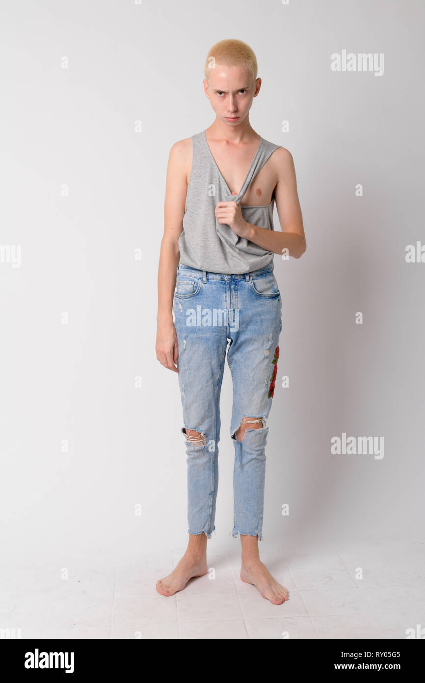 Full body shot of young handsome androgynous man holding shirt Stock ...
