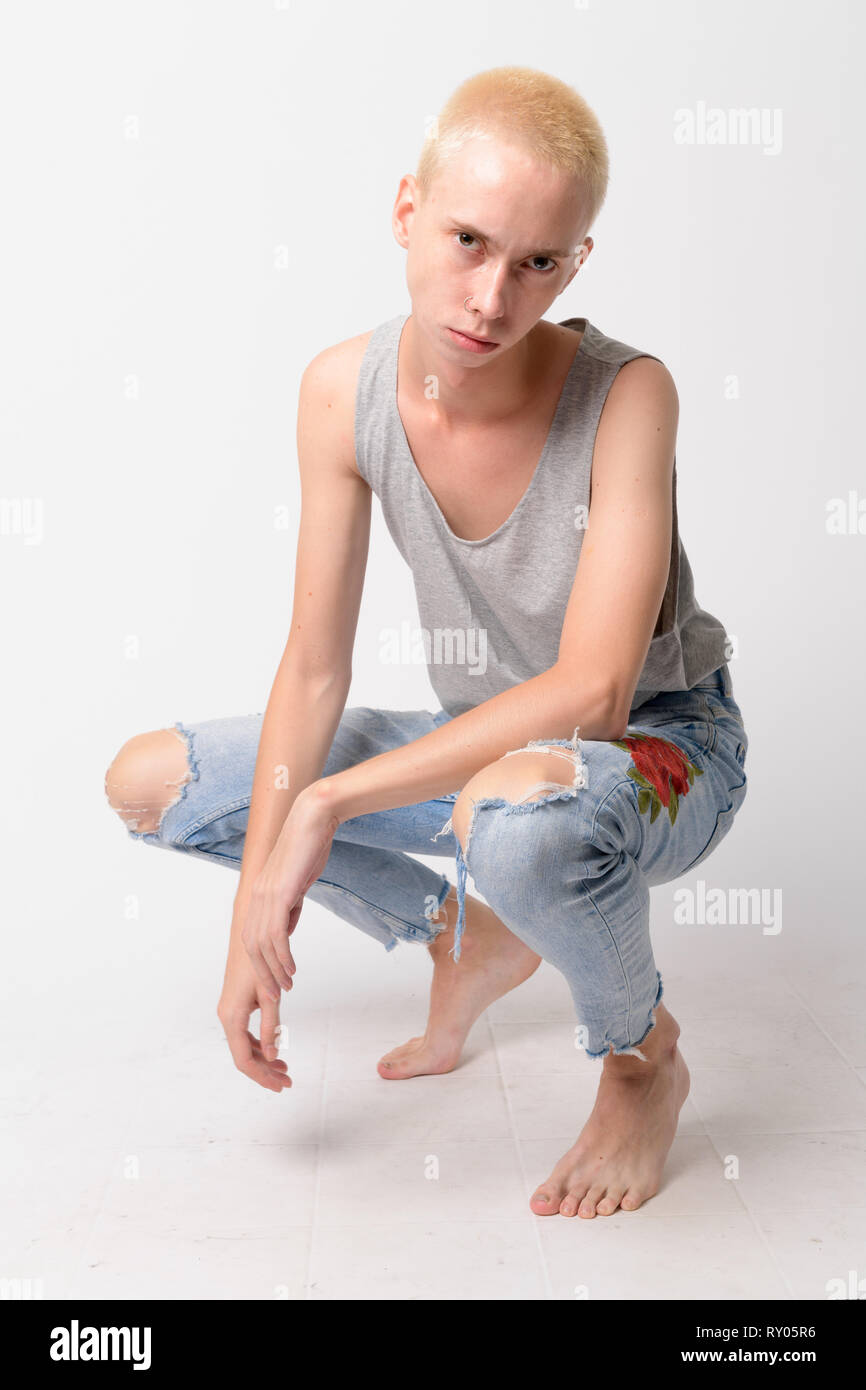 Slim man 20s crouching hi-res stock photography and images - Alamy