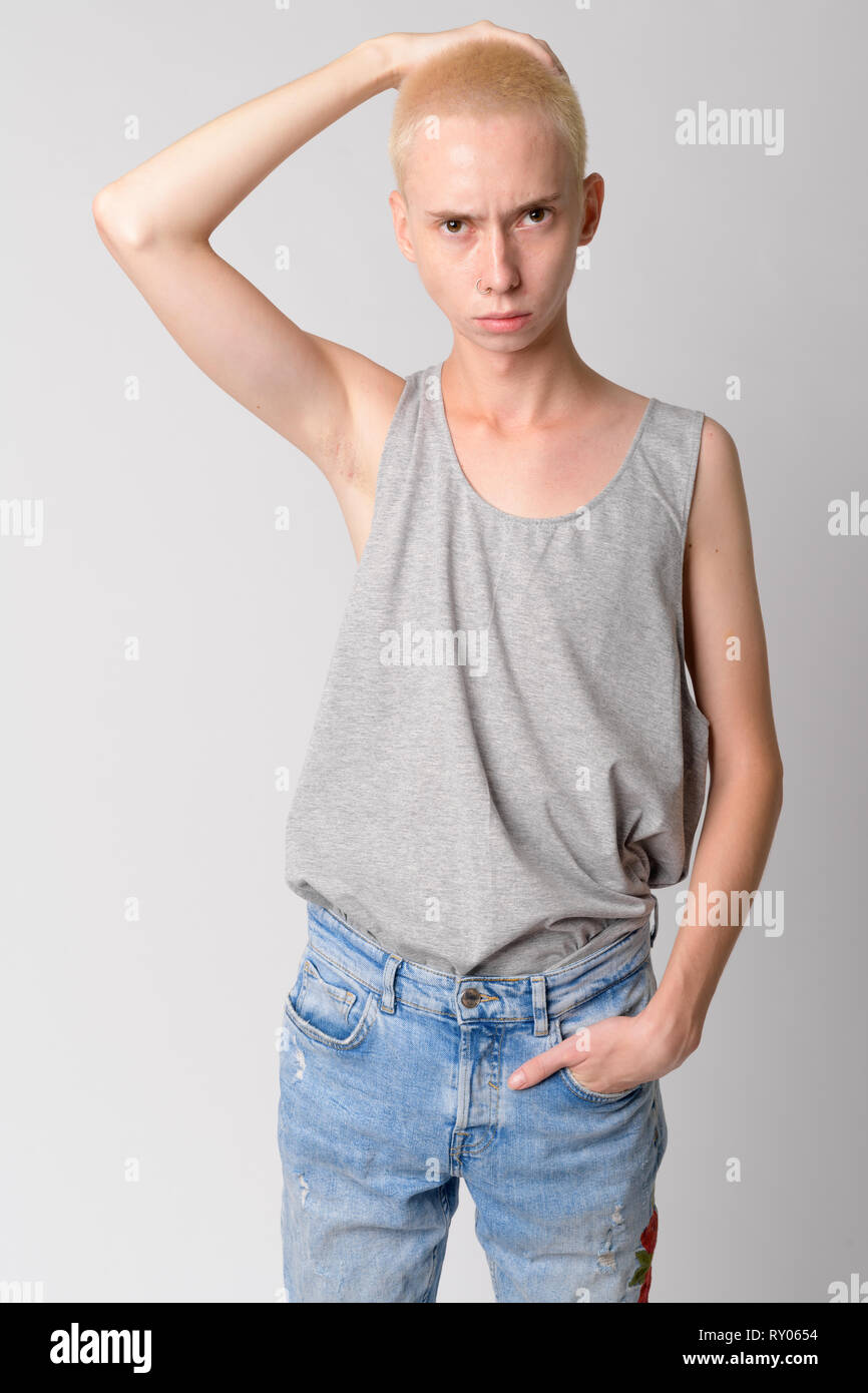 Portrait of young handsome androgynous man touching head Stock Photo ...
