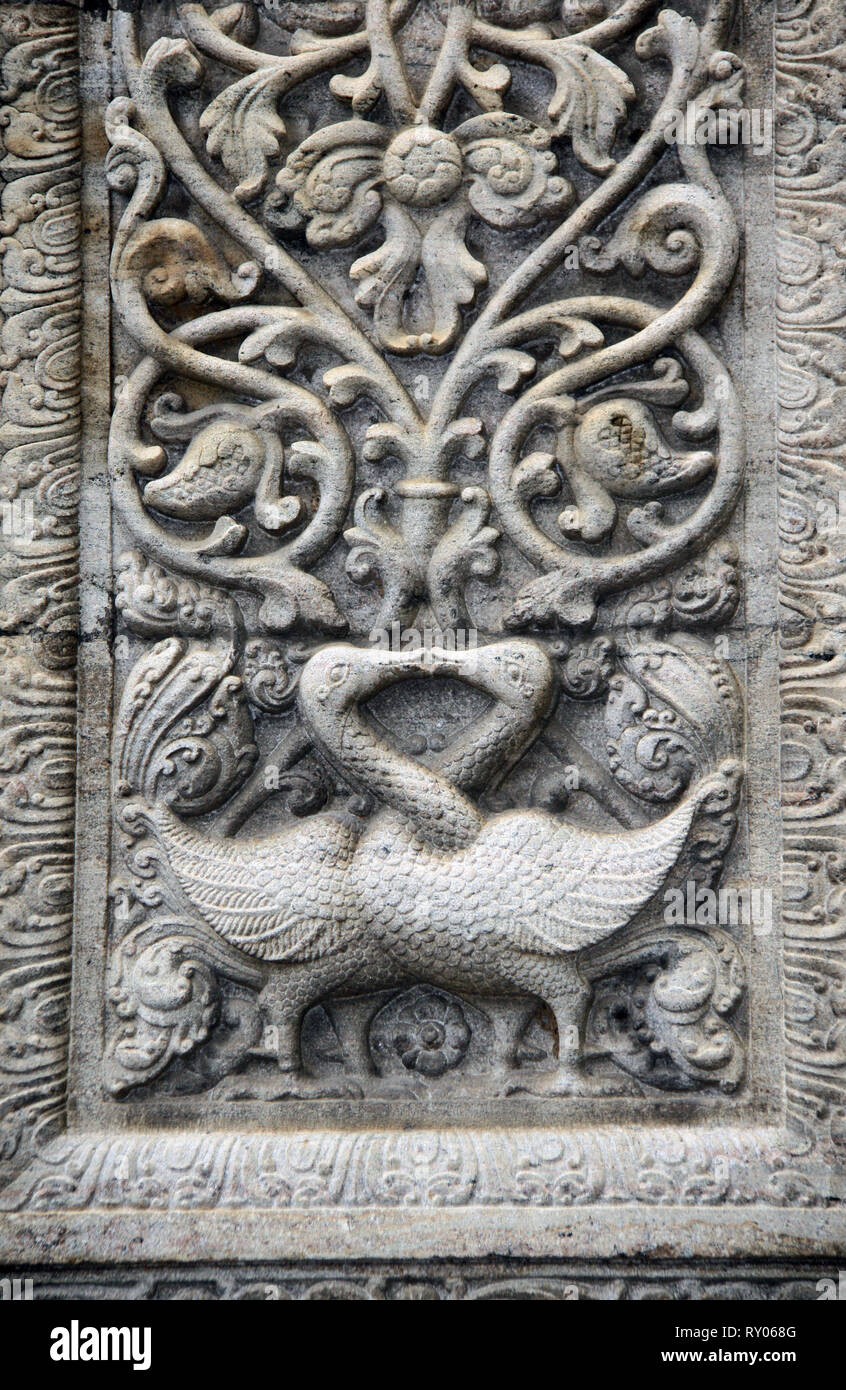 Stone bas-relief with two kissing swans and floral ornament on wall of ...
