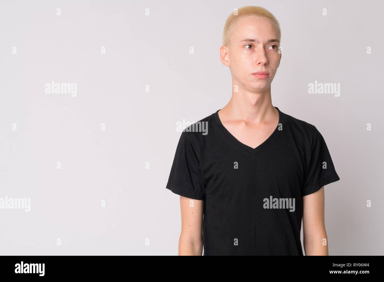 Portrait of young handsome androgynous man thinking Stock Photo - Alamy