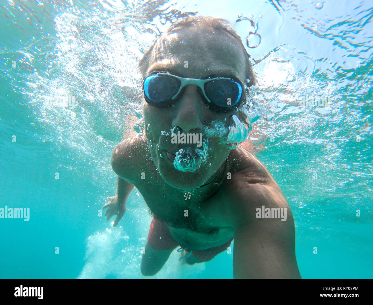 Man swimming underwater in the sea Stock Photo - Alamy