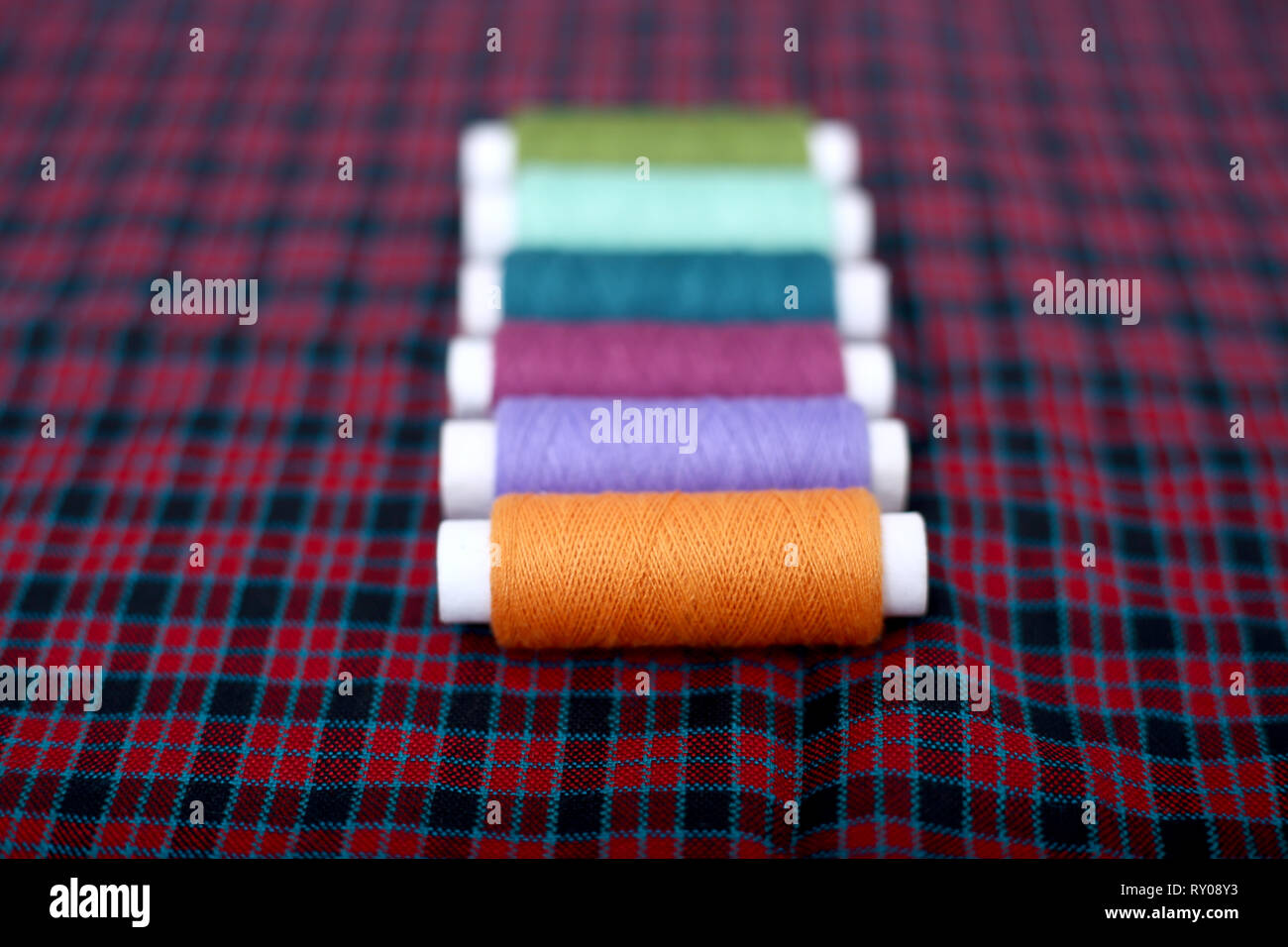Photo of colored sewing thread on the cloth Stock Photo - Alamy