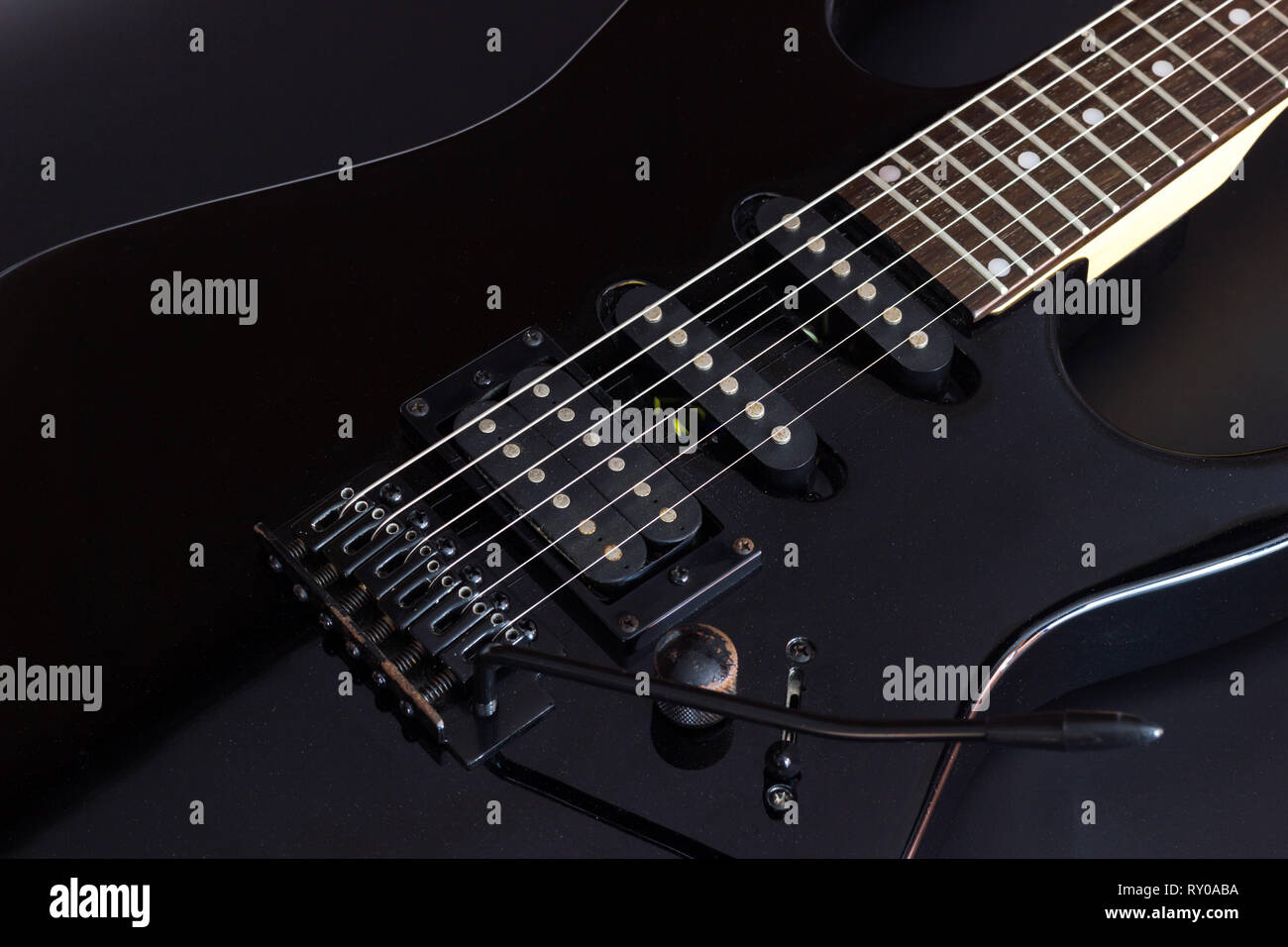 Black electric guitar on dark background Stock Photo - Alamy