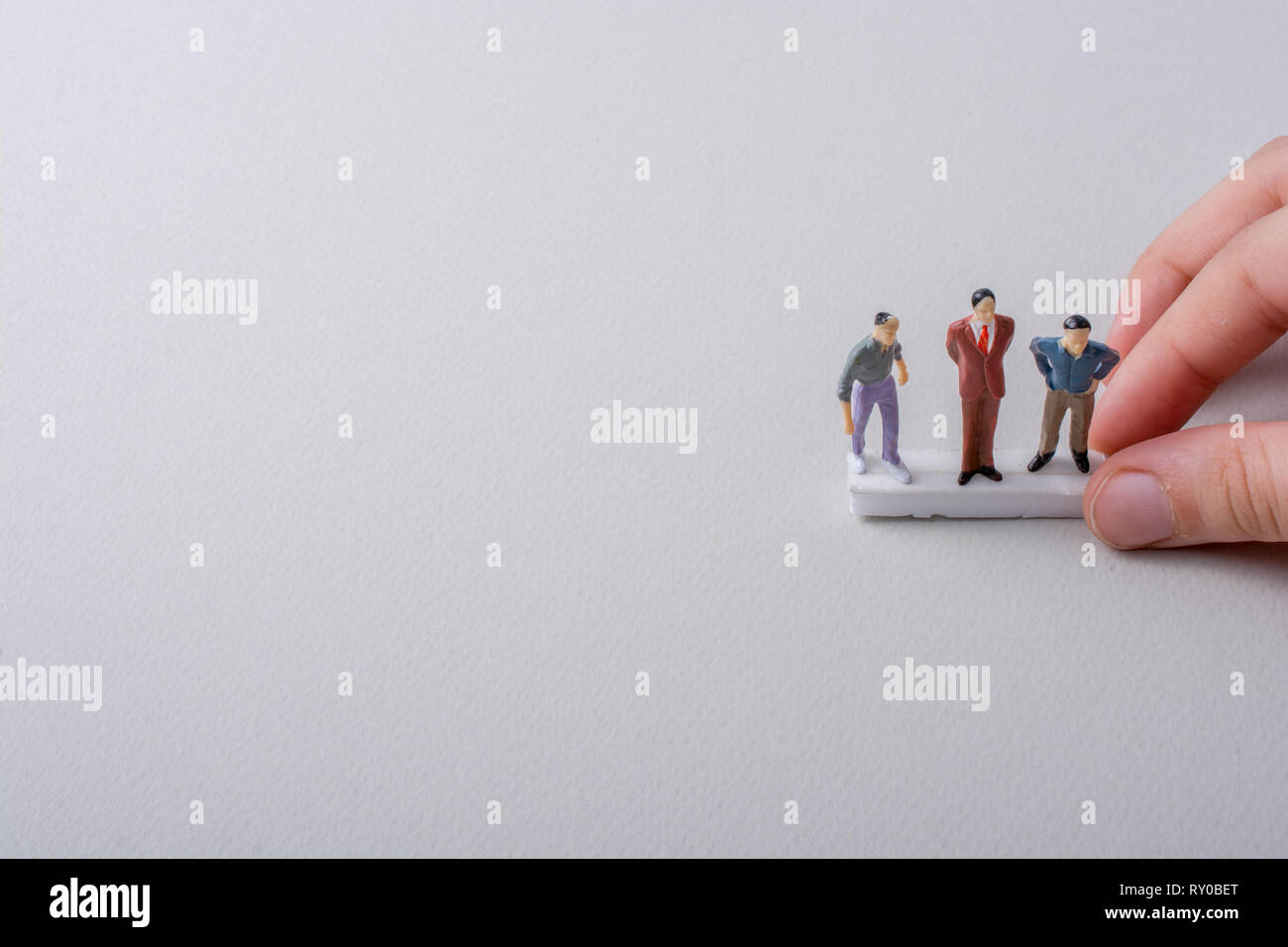Tiny figurines of men miniature model in hand Stock Photo - Alamy