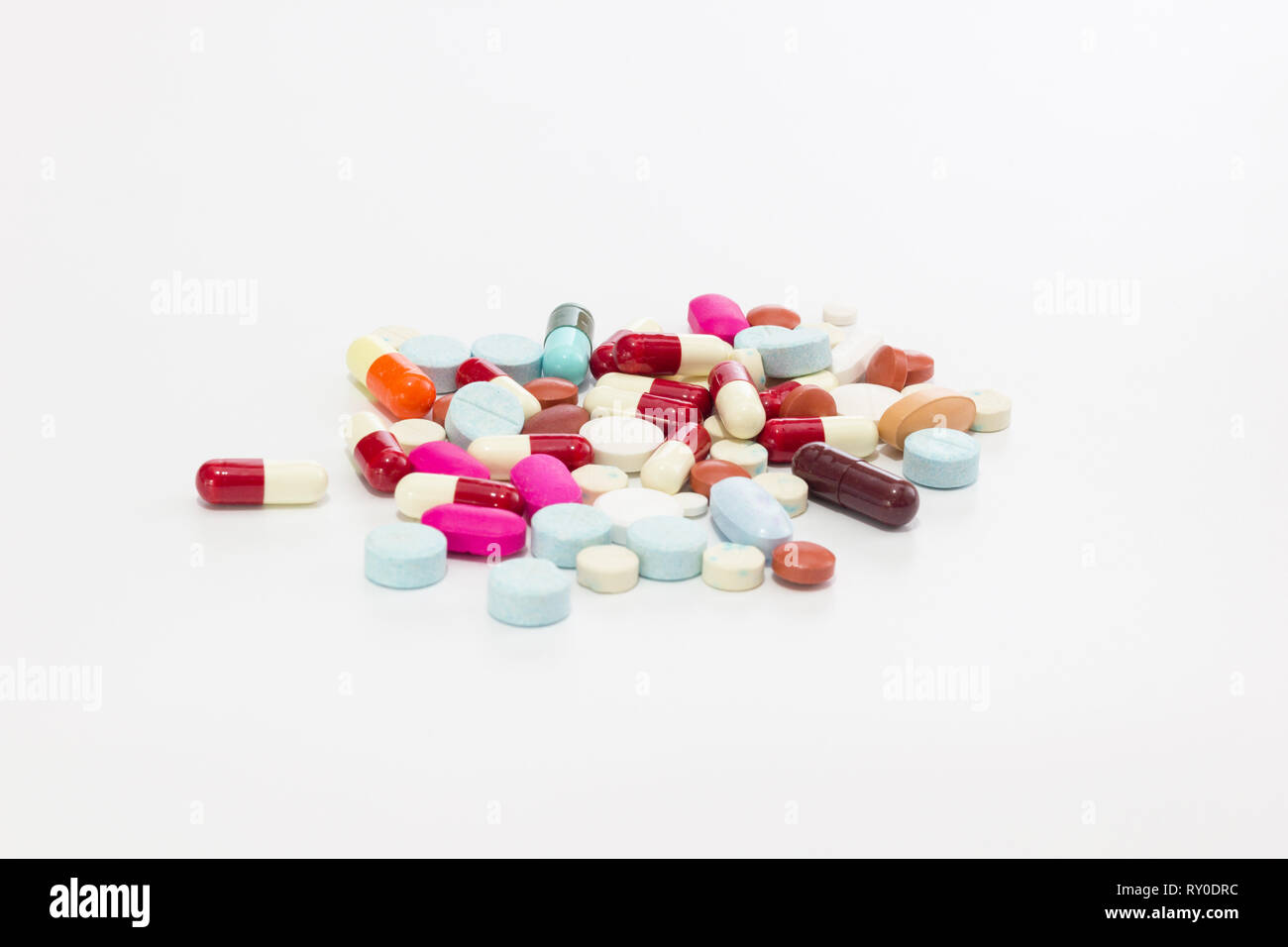 Multicolor antibiotics tablets and capsules on white background Stock ...