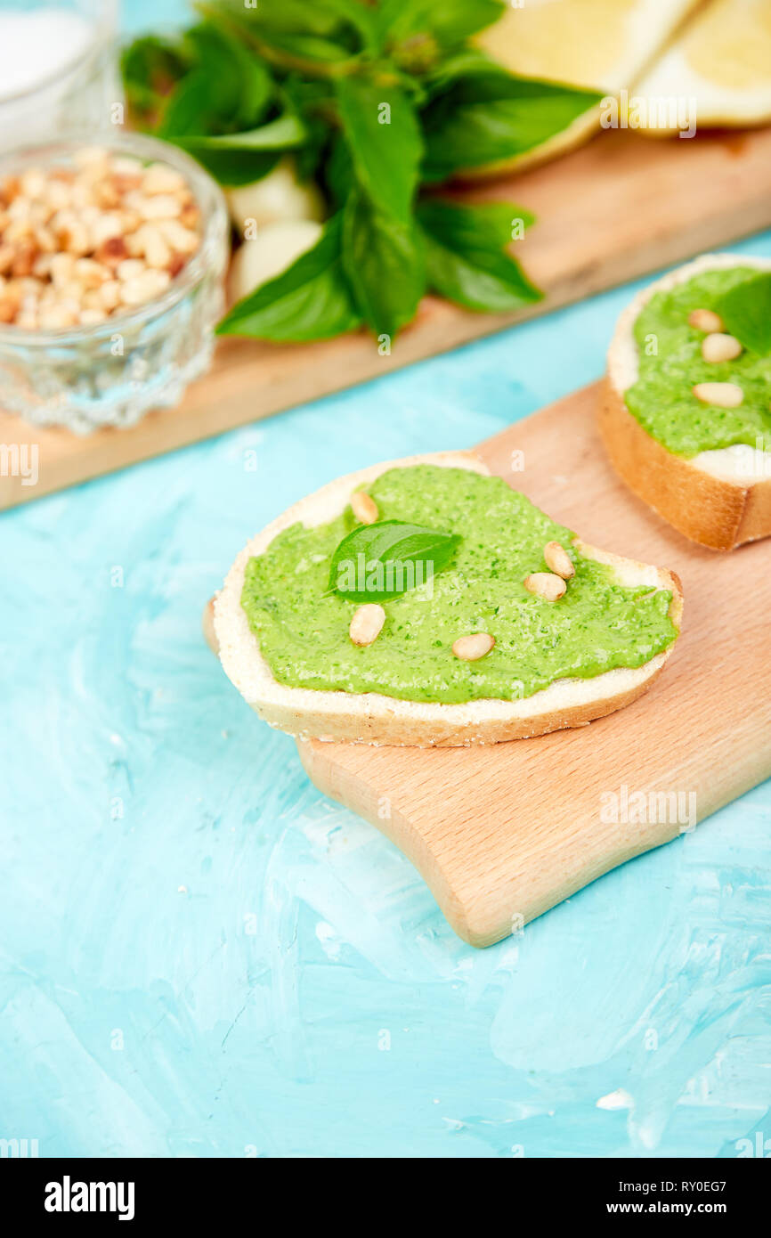 Bruschetta bread with pesto sauce, parmesan cheese and fresh basil ...