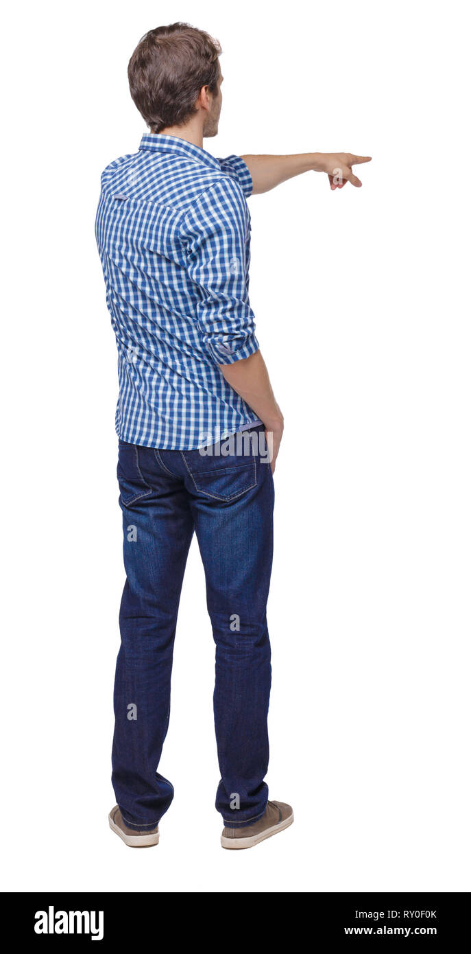 Back view of a man in jeans points his hand upwards. Rear view people ...