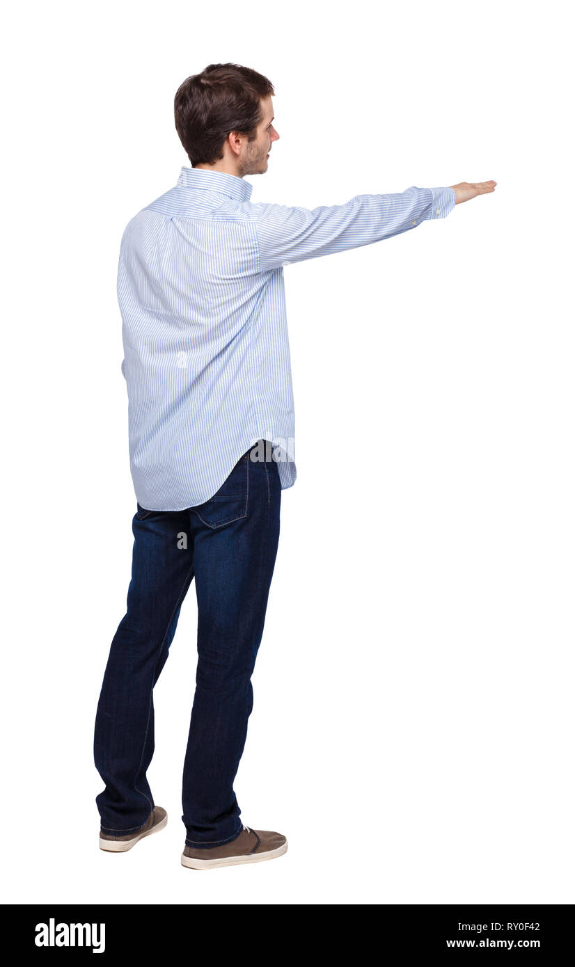 Back view of a man in jeans points his hand upwards. Rear view people ...