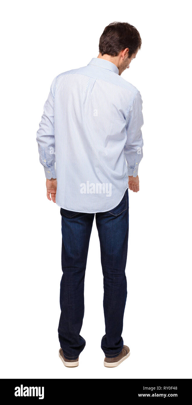 Back view of a man in jeans points his hand upwards. Rear view people ...