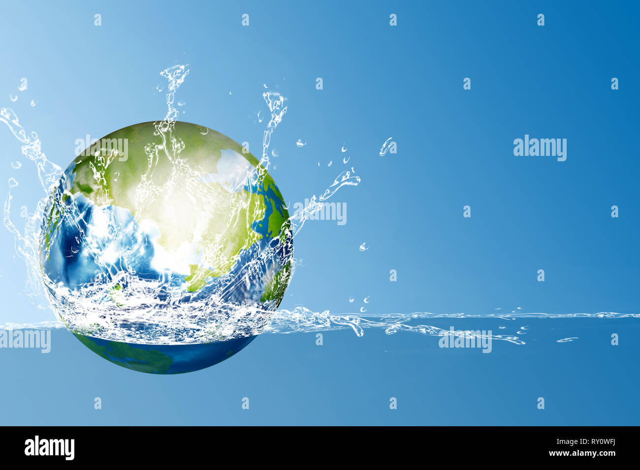 Earth planet on the water with splash over blue background. Earth hour ...