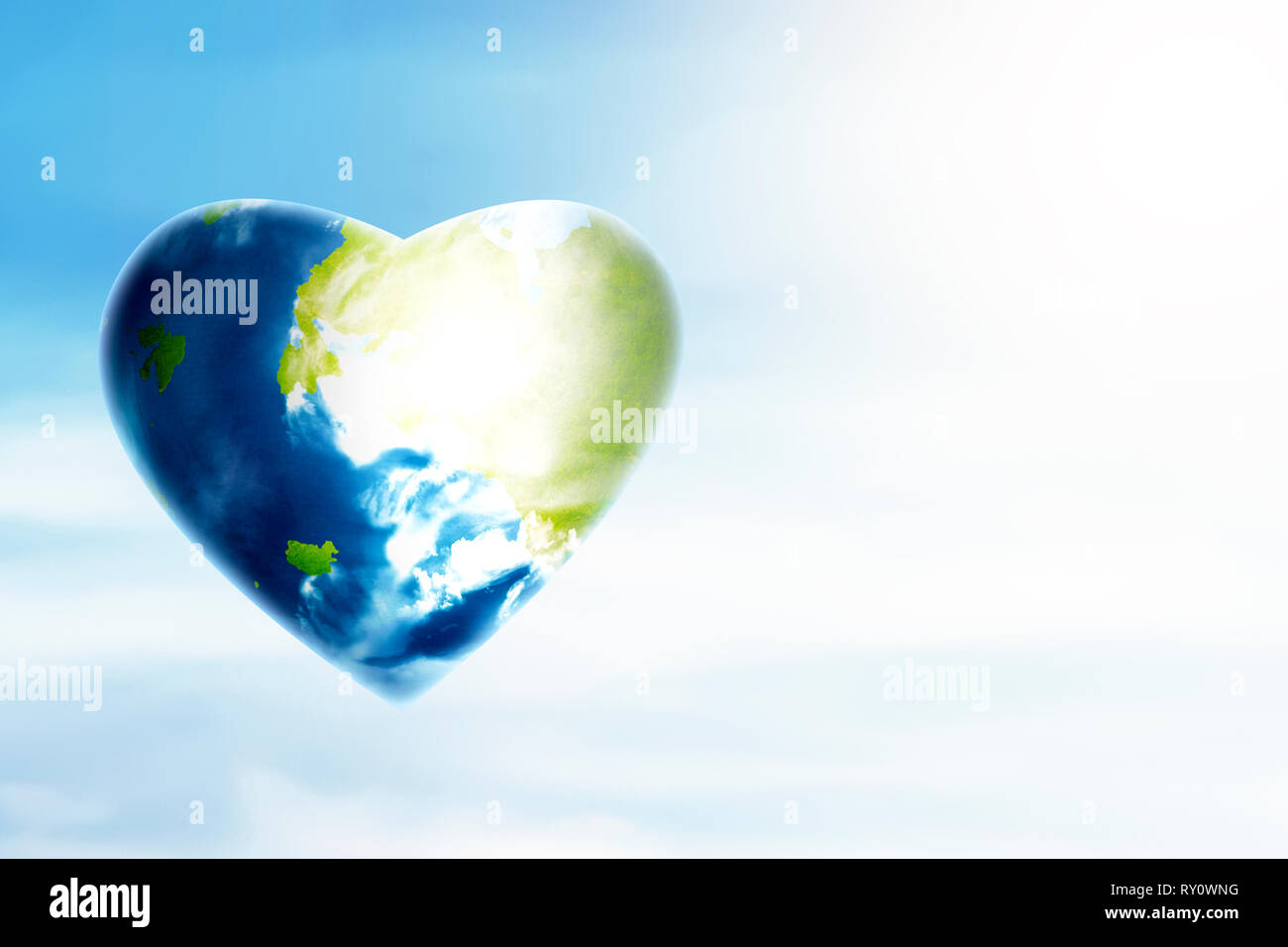 Earth planet with heart shape over blue sky background. Earth hour ...