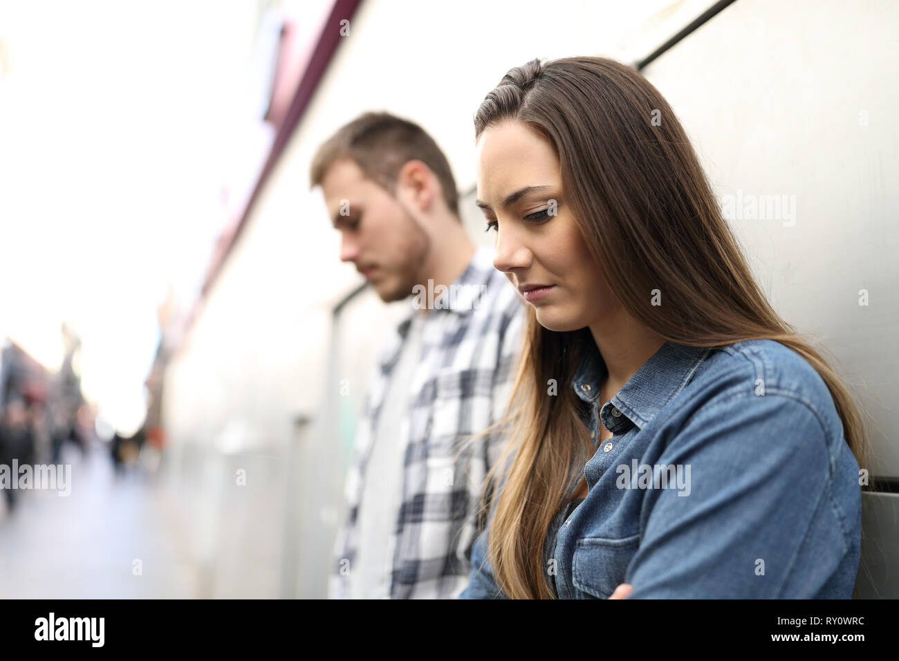Sad couple or friends complaining ignoring each other in the street ...