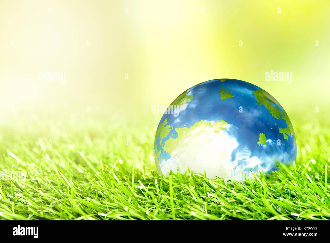 Earth planet on the green grass with green background. Earth hour ...
