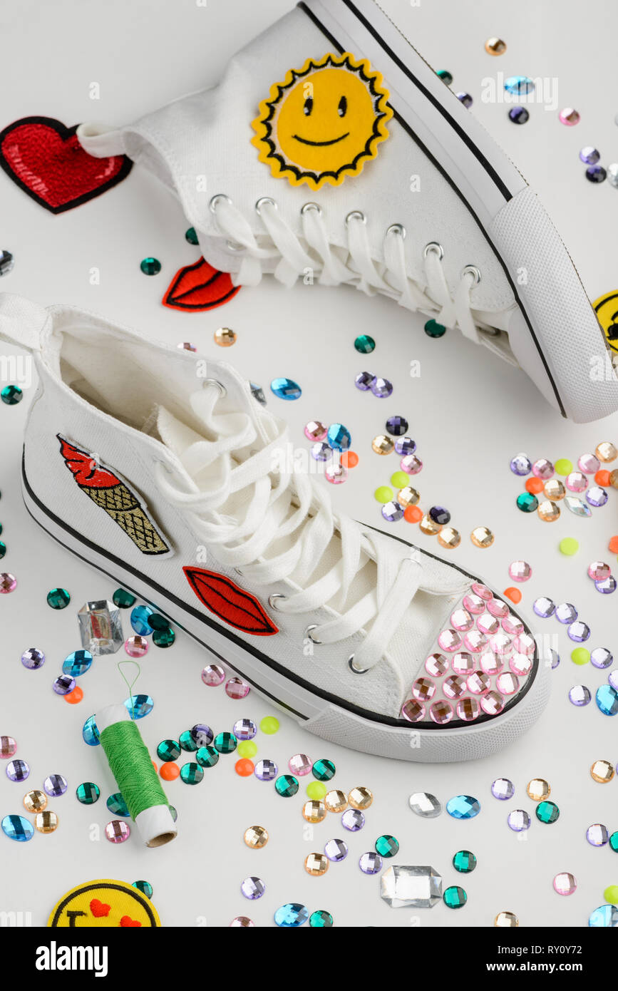 White sneakers decorated with rhinestones Stock Photo - Alamy